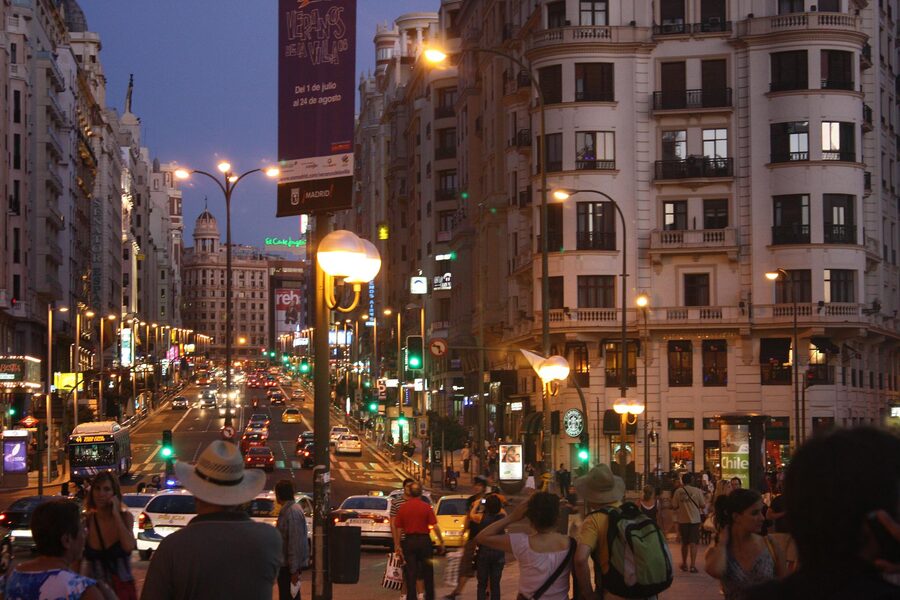 Gran Via in Madrid at night with illuminated buildings and traffic