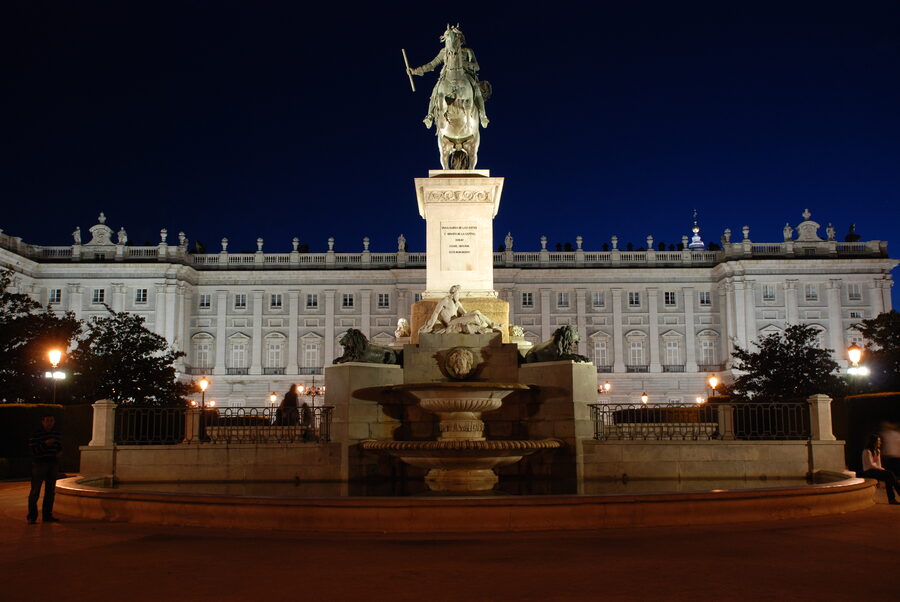 The Royal Palace of Madrid seen at night with warm lighting