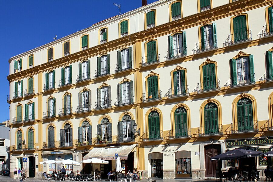 The birthplace of Pablo Picasso on Plaza de la Merced in M&aacute;laga, a cream-colored corner building