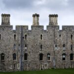 Stone facade of Windsor Castle against dramatic skies in England