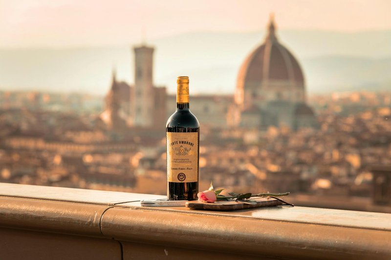 A bottle of Tuscan wine on a balcony overlooking the Florence skyline with the cathedral dome