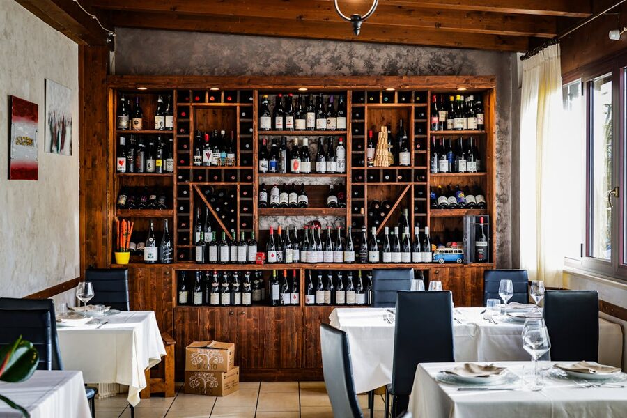 A restaurant interior with a large wine collection on display