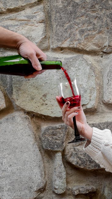 Candid shot of red wine being poured at a tasting event