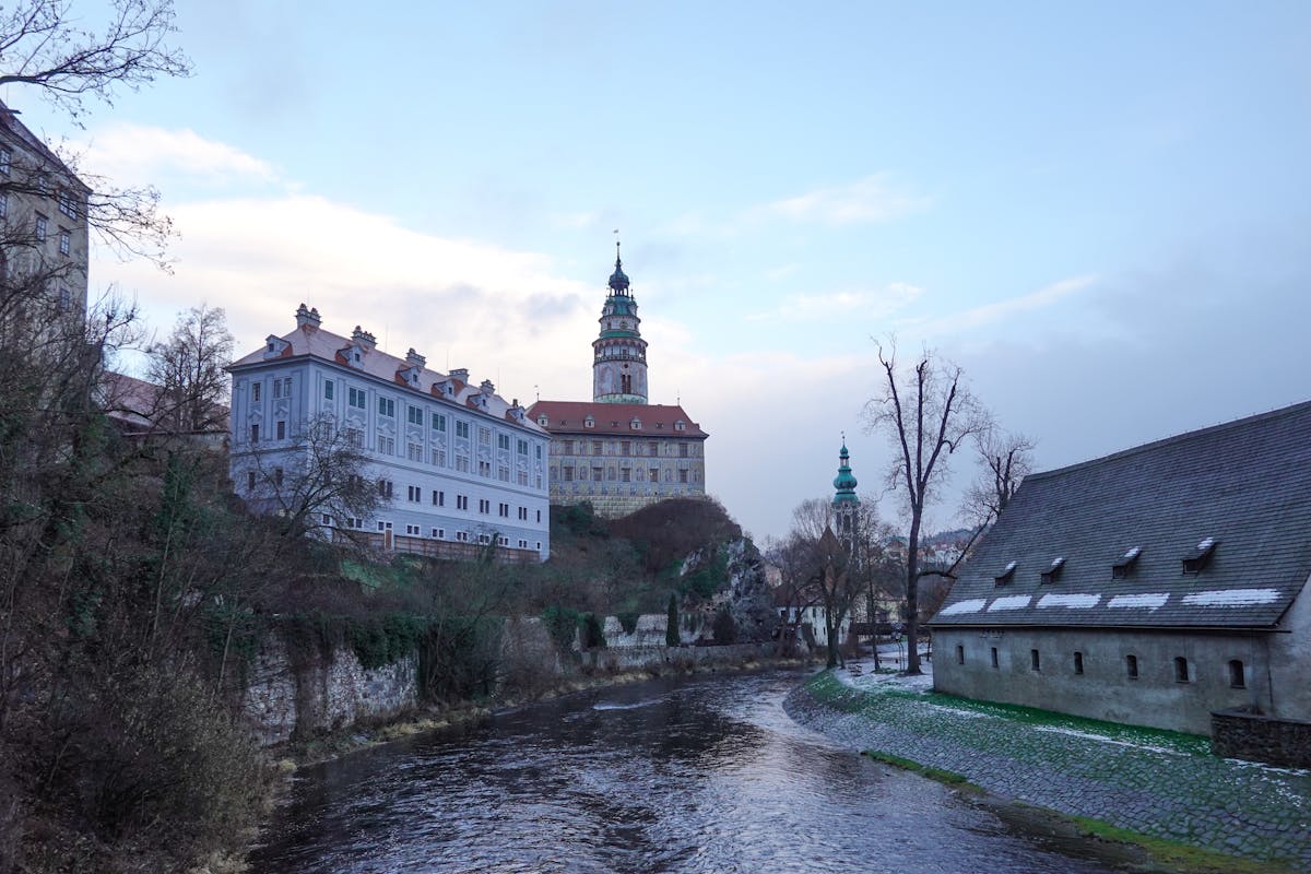 Cesky Krumlov Castle illuminated during winter twilight with the river in the foreground