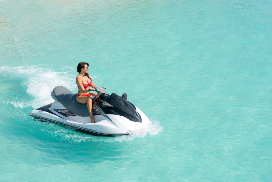 Woman on a jet ski in clear turquoise ocean water