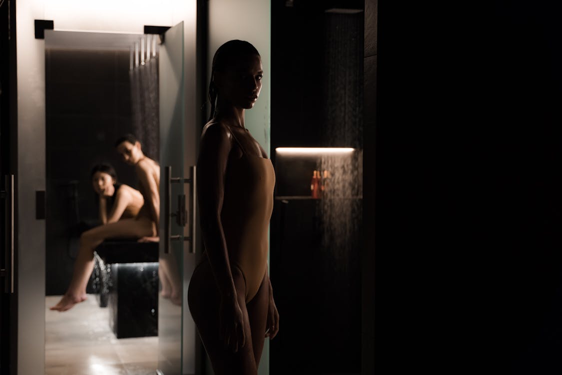 Women in swimsuits at a stylish dimly lit indoor spa setting