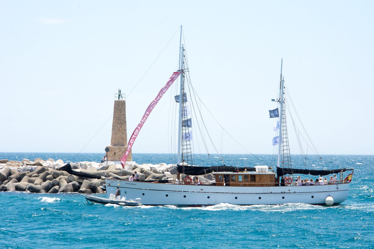 Beautiful yacht sailing near a lighthouse in Marbella Spain